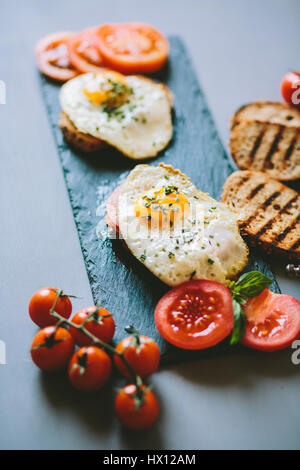Breakfast with eggs, tosst and tomatoes Stock Photo - Alamy
