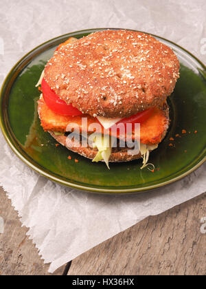 Homemade fish burger with organic ingredients on a rustic plate Stock ...
