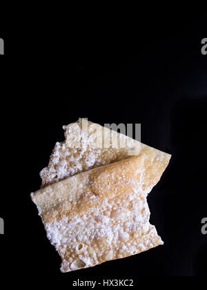 Oreillettes, bugnes or angel wings. Traditional french pastry sprinkled ...