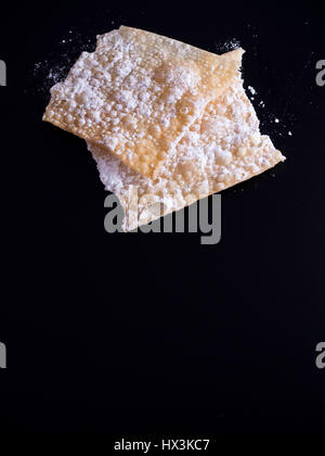 Oreillettes, bugnes or angel wings. Traditional french pastry sprinkled ...