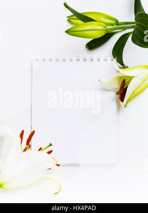 Beautiful bouquet of flowers and empty paper for text on wooden table ...