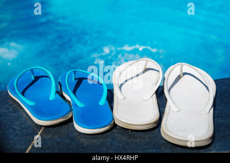 Beach slippers on border of a swimming pool - holiday tropical concept ...