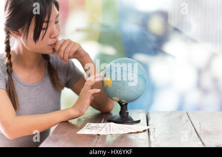 Women explore the globe to plan their trip Stock Photo - Alamy