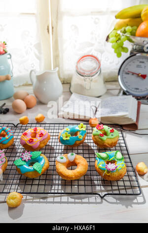 Decorating sweet donuts in the rustic kitchen Stock Photo - Alamy