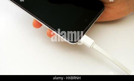 Female hand plugging charger cell phone smartphone Stock Photo - Alamy