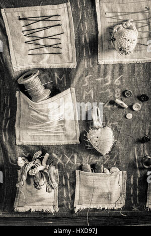 Old sewing cloth made of threads, needles and buttons in tailor ...