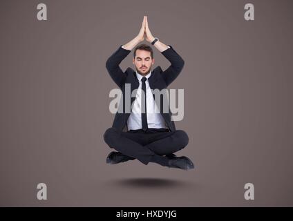 Digital composite of Businessman Meditating floating against grey ...