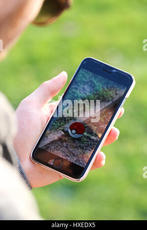 Young Male playing Pokemon Go outdoors Stock Photo - Alamy