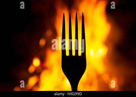 hell fork on the background of fire Stock Photo - Alamy