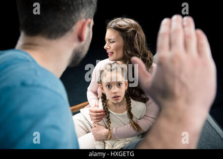 father protecting daughter from aggressive mother, family violence ...