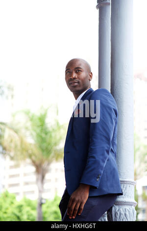 Pensive black man standing outside in city downtown. Thoughtful African ...