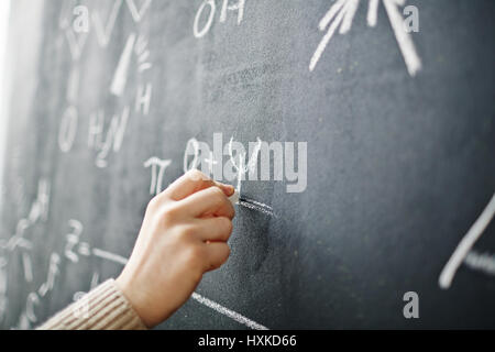 Hand scientist writing formulas Stock Photo - Alamy