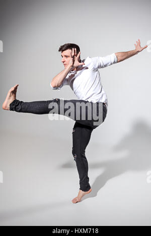 The young man dancing on gray Stock Photo - Alamy