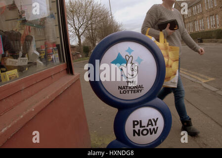 the national lottery play now sign display in deprived area shopping ...