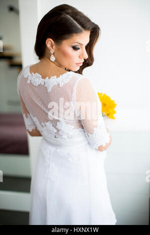 Beautiful pregnant woman holding a bouquet from a Christmas tree on a ...
