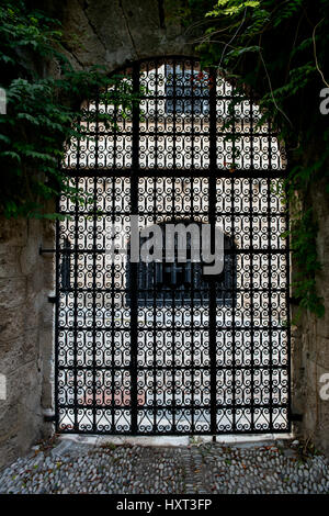 Medieval iron gate in ancient stone wall Stock Photo - Alamy