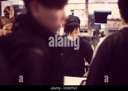 A Chinese cashier at the counter of McDonalds in Hong Kong, China. The ...