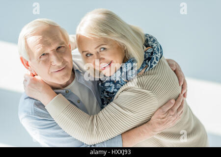high angle view of happy senior man with beard holding vintage camera ...