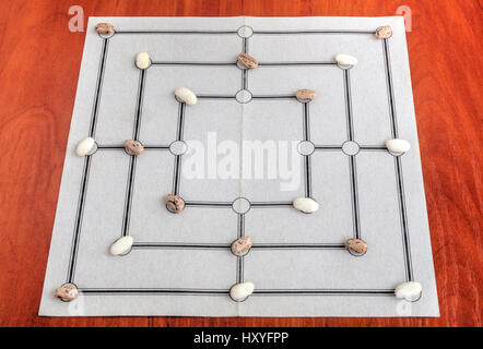 Traditional board for playing Nine Men's Morris game Stock Photo - Alamy