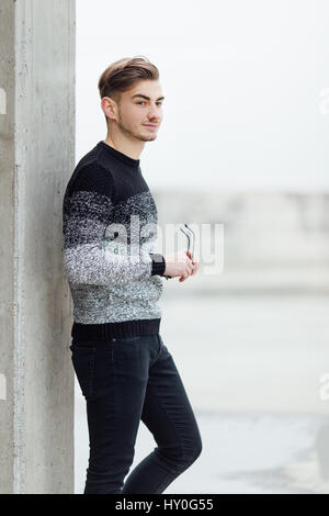 man standing near a wall Stock Photo - Alamy