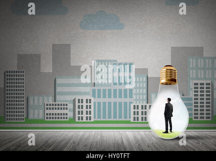 Businessman trapped in bulb Stock Photo - Alamy