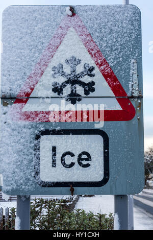 Ice warning sign on the A836 trunk road in snowy weather, at the ...