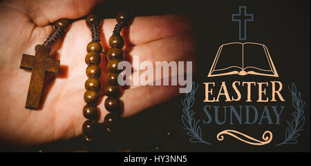 Easter message against hand holding rosary beads Stock Photo - Alamy