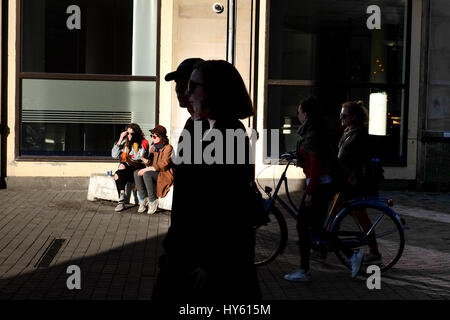 People resting in the shadow near a fountain pictured in Brussels ...