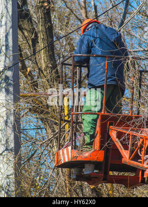 A worker on the stairs removes ragged wires Stock Photo - Alamy