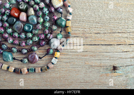 Beautiful semiprecious stone beads on wooden background closeup Stock ...