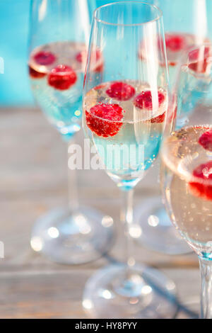Champagne glasses with raspberry. Summer pool party Stock Photo - Alamy