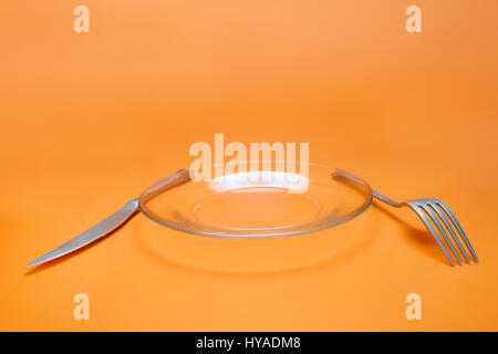 Perspective view of empty orange plate on cement background. Empty ...