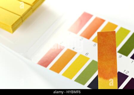 universal indicator paper with acidic testing Stock Photo - Alamy