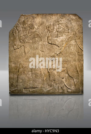 Assyrian relief sculpture panel of Tribute bearers, the first one has a ...