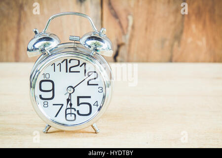 Wall clock show six o'clock on white marble texture. Office clock show ...