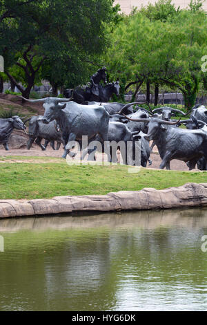 Multiple bronze statues form part of an old west cattle drive sculpture ...