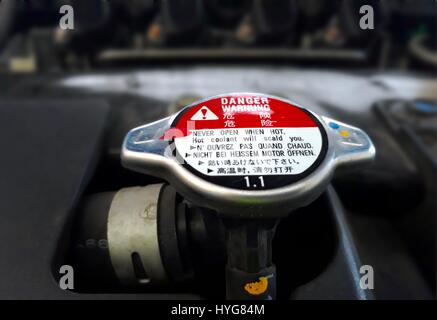 Radiator cap with warning label of a car Stock Photo - Alamy