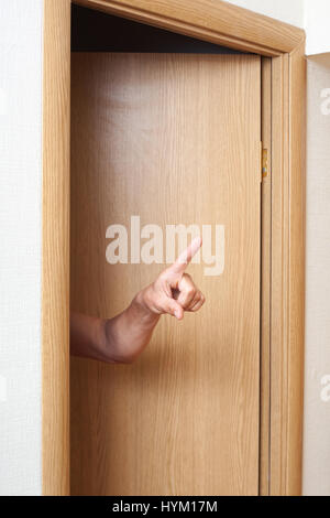 Hand in doors pointing Stock Photo - Alamy