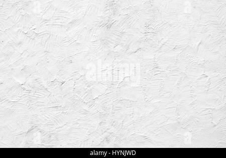 Wall of rough cement render painted white as an abstract background ...