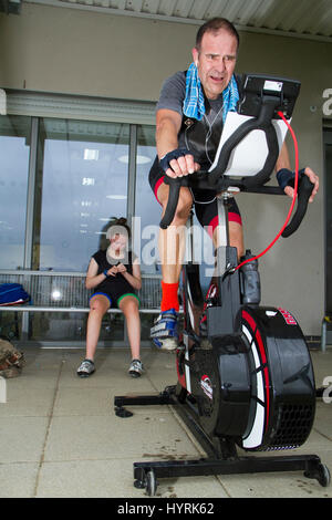 Middle aged man trying hard on a stationary cycle trainer Stock Photo ...