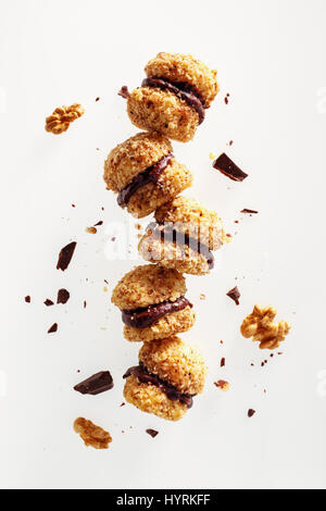 Stack rich dark chocolate cookies on light rustic wooden background ...