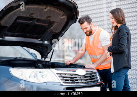 Man providing car technical assistance Stock Photo - Alamy