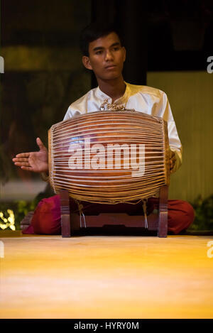 Playing Cambodian traditional musical instrument Kong toch at Wat Phnom ...