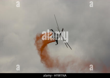 Military helicopter in flight, smoke Stock Photo - Alamy