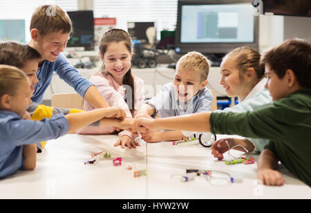 happy children making fist bump at robotics school Stock Photo - Alamy