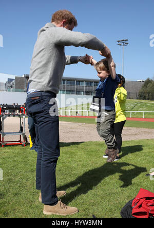 Prince Harry plays with Harry Phillips, 2, as he watches the UK team ...