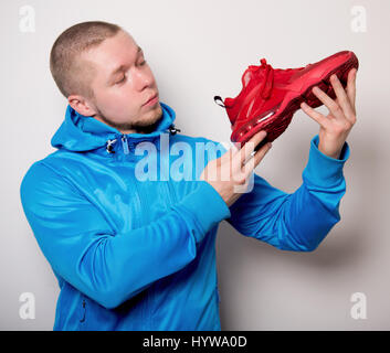 guy picks sneakers Stock Photo - Alamy