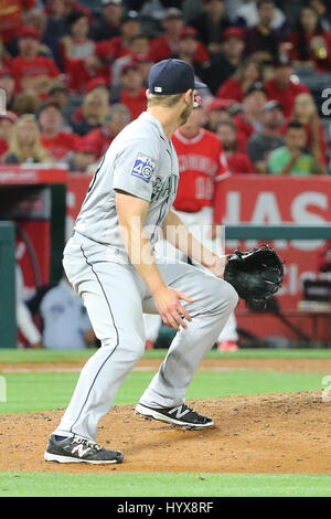Seattle Mariners relief pitcher Casey Lawrence, left, fields a ball off ...