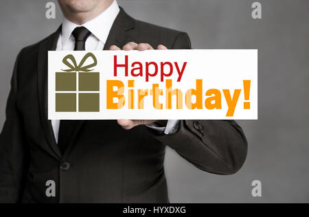 Happy Birthday shield is held by businessman Stock Photo - Alamy