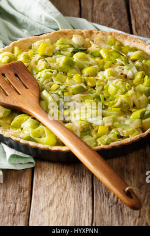 Homemade leek quiche with a baked cheese crust in a glass dish, cooling ...